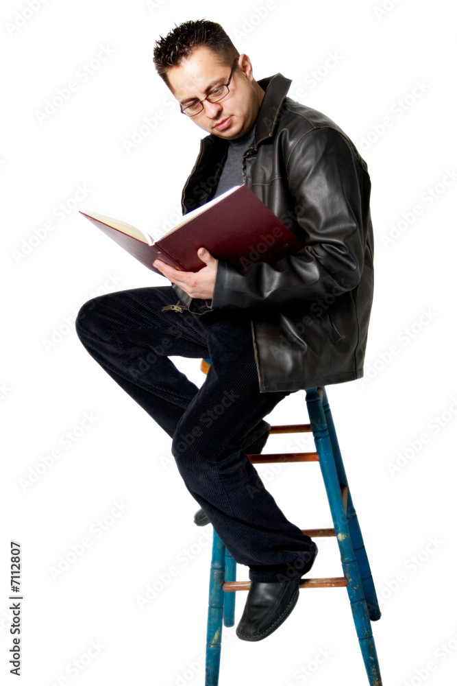 Isolated young man sitting down & reading a book Stock Photo | Adobe Stock