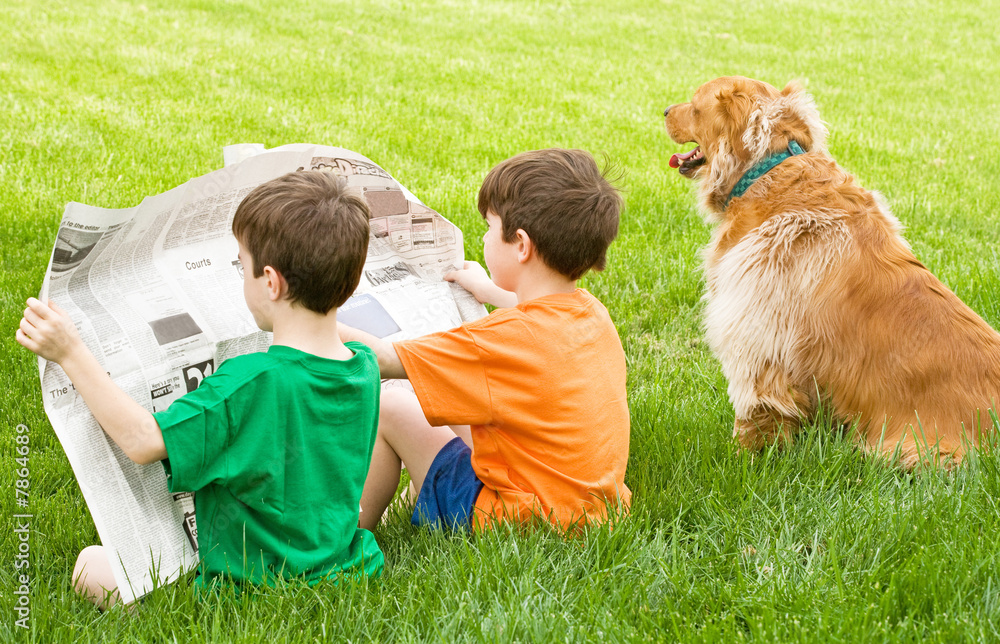 Two Boys Reading the Newspaper Stock Photo | Adobe Stock