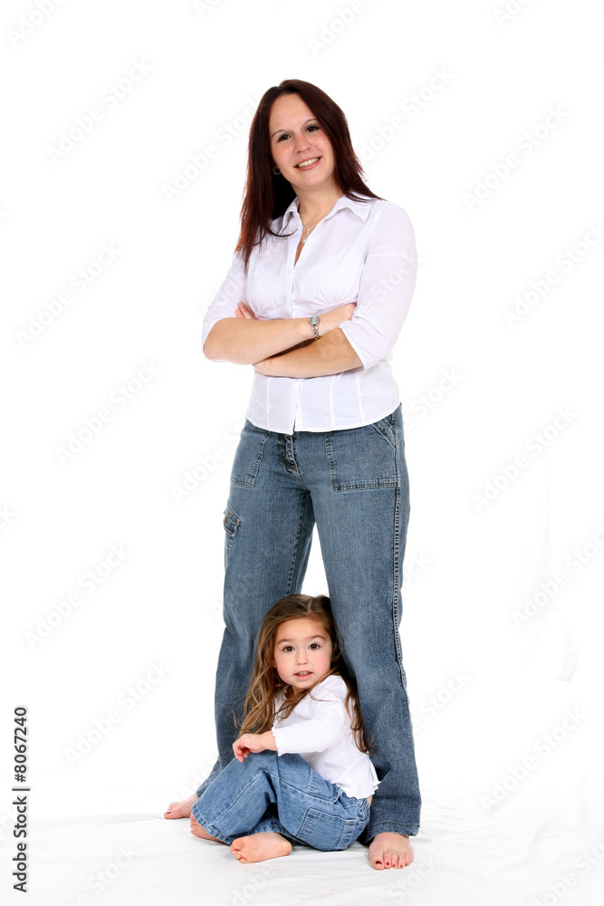 Young little girl sitting on floor between her mother's legs. Stock ...
