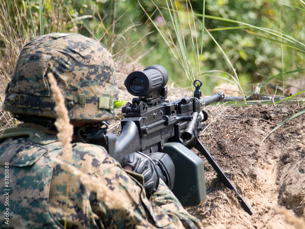 Soldier shooting his machine gun Stock Photo | Adobe Stock