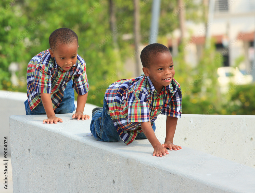 Kids crawling on a ledge Stock Photo | Adobe Stock