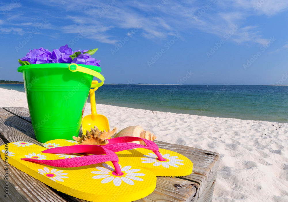 Colorful beach accessories on boardwalk by ocean Stock Photo | Adobe Stock