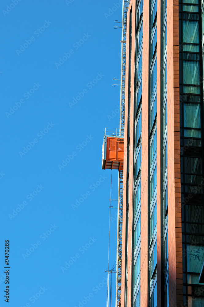 elevator rising and lifting people to work on new building Stock Photo ...
