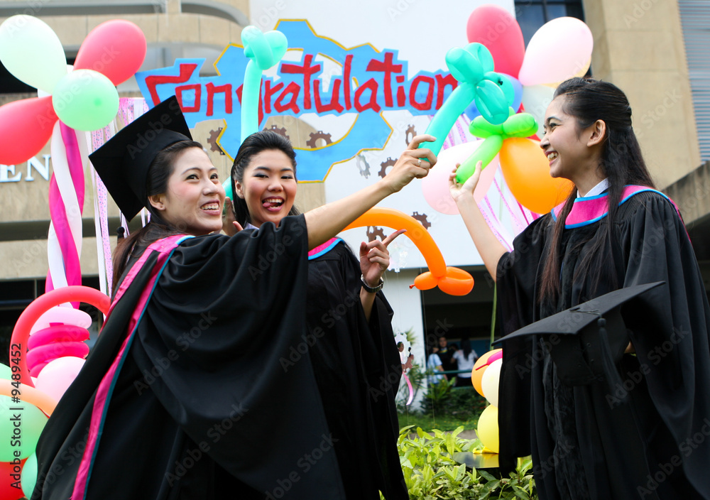 Beautiful Asian university graduates celebrate their success. Stock ...