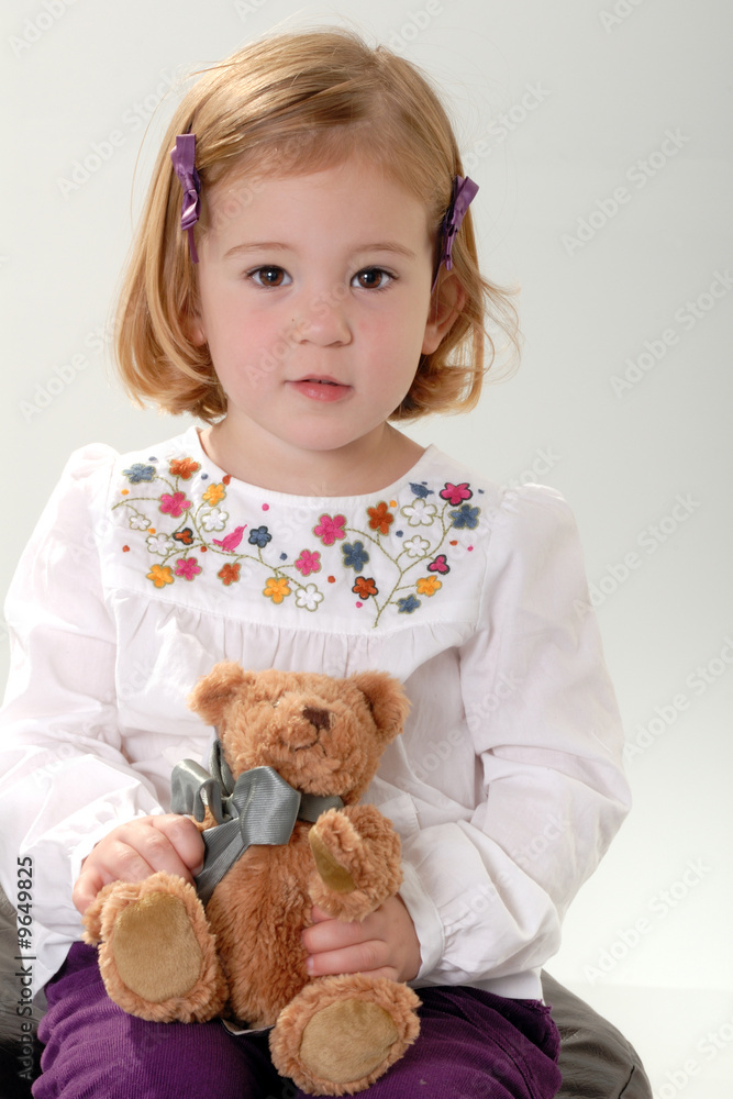 cute two year old blonde toddler poses with teddy Stock Photo | Adobe Stock