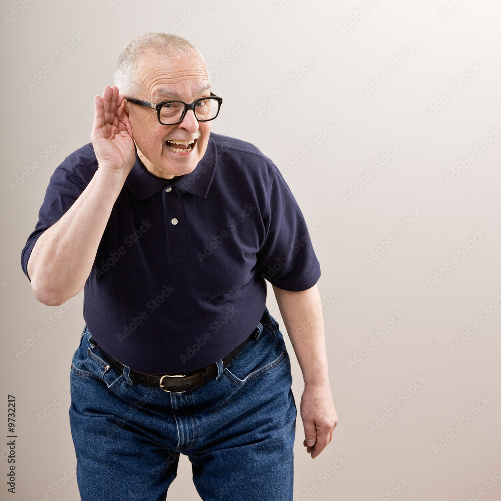 Man cupping his ear having difficulty hearing Stock Photo | Adobe Stock