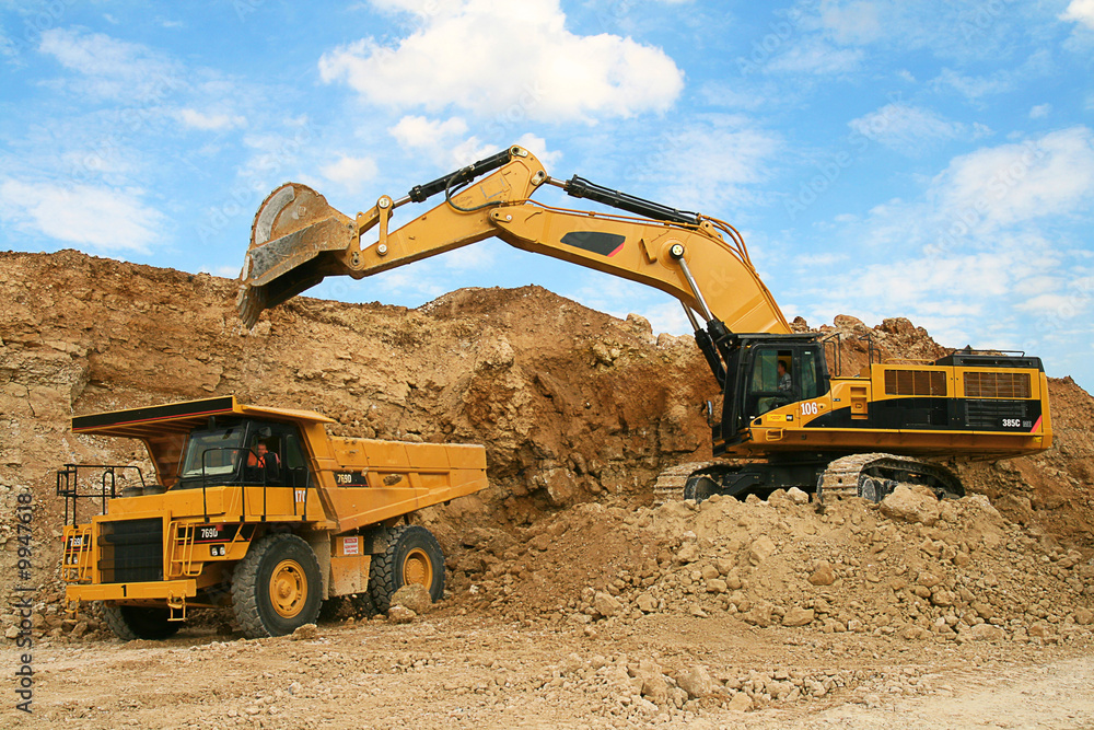 Backhoe loader loading dumper Stock Photo | Adobe Stock