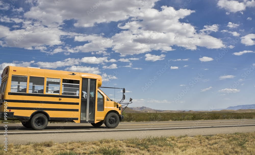 Small school bus on the road Stock Photo | Adobe Stock