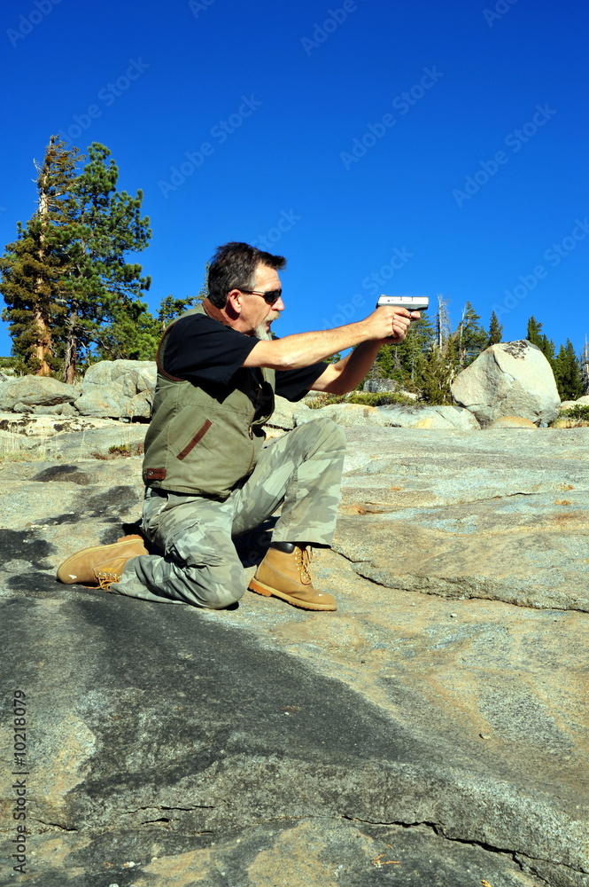 Man target shooting in a kneeling position Stock Photo | Adobe Stock