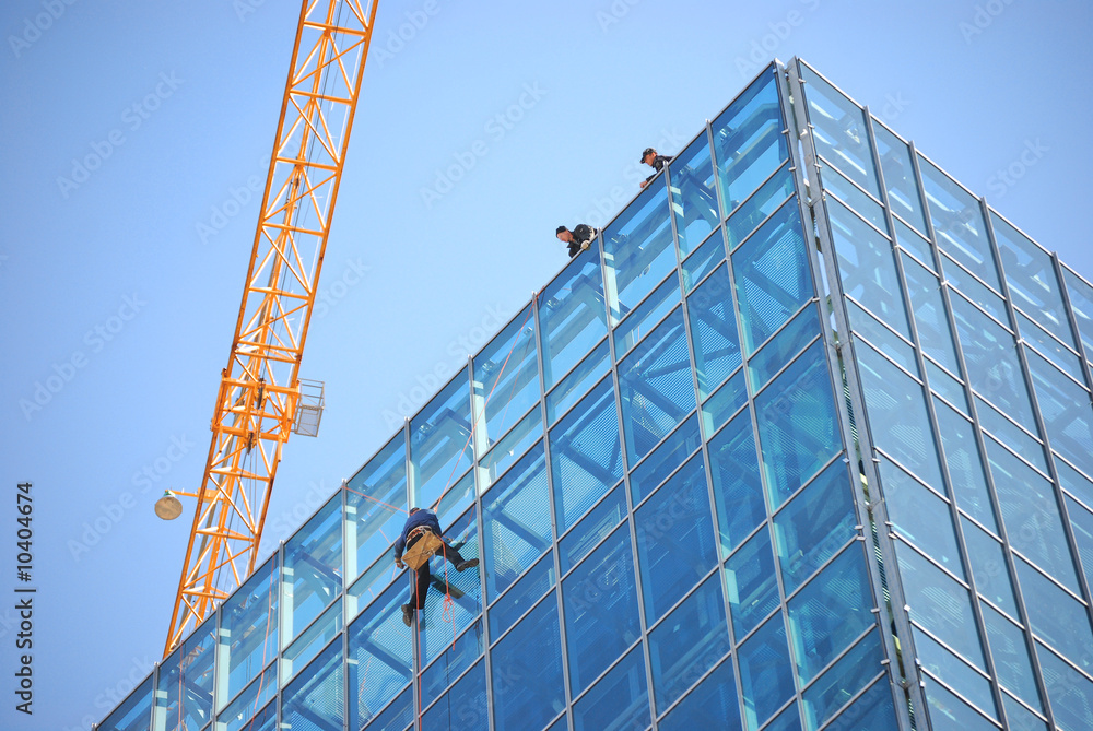 Building construction with crane with man washing glass windows Stock ...