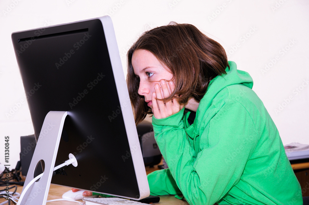 girl staring at computer screen Stock Photo | Adobe Stock