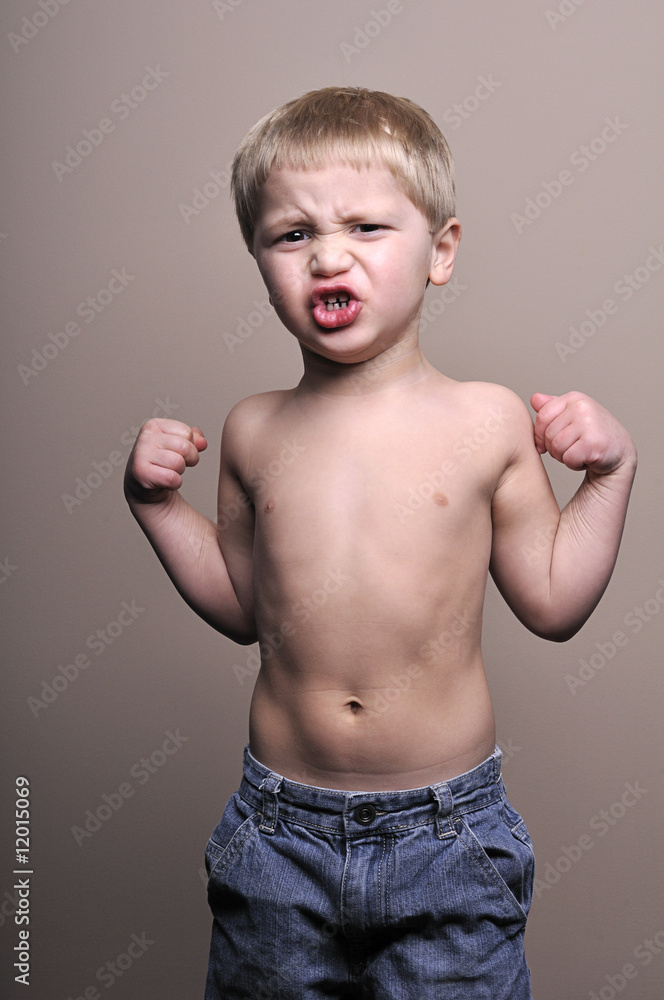 Little boy flexing muscles Stock Photo | Adobe Stock
