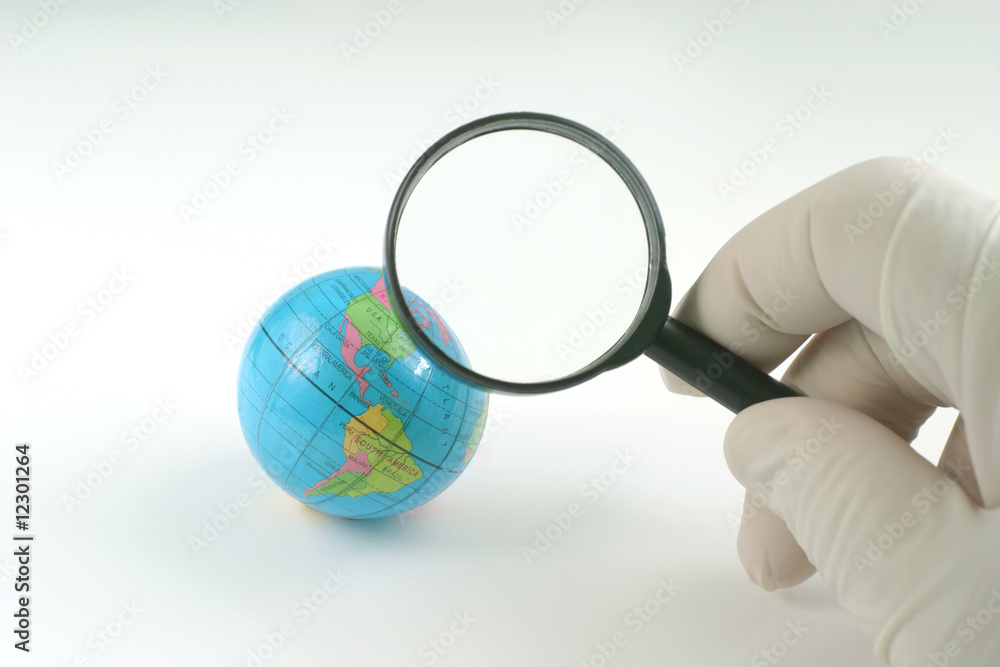 Earth globe & magnifying glass Stock Photo | Adobe Stock