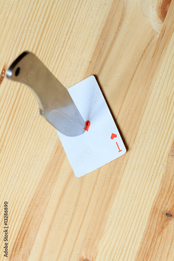 Direct hit to playing card with missile knife Stock Photo | Adobe Stock