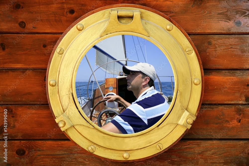 Sailor on sailboat, from boat round window Stock Photo | Adobe Stock