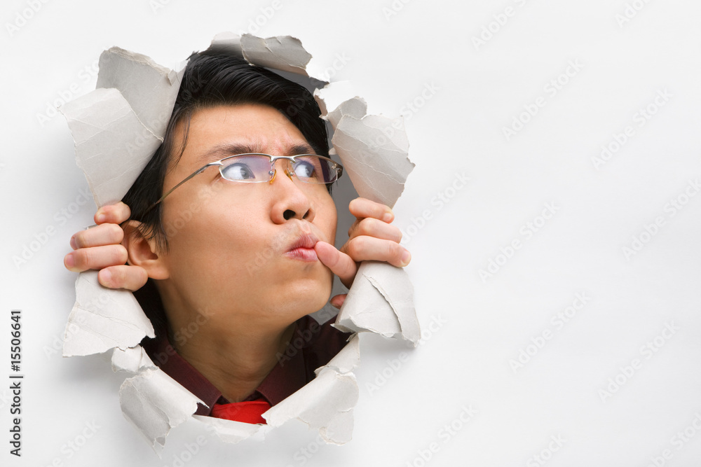 Thoughtful man from hole in wall seriously looking his blank le Stock ...