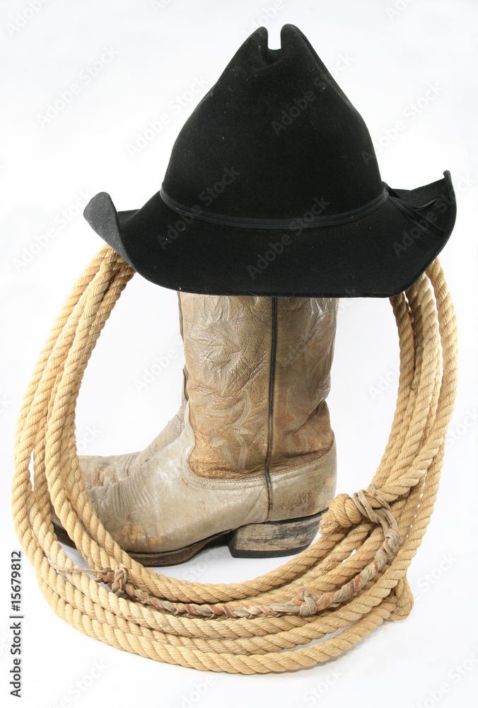 Worn cowboy boots with rope and hat side view Stock Photo | Adobe Stock