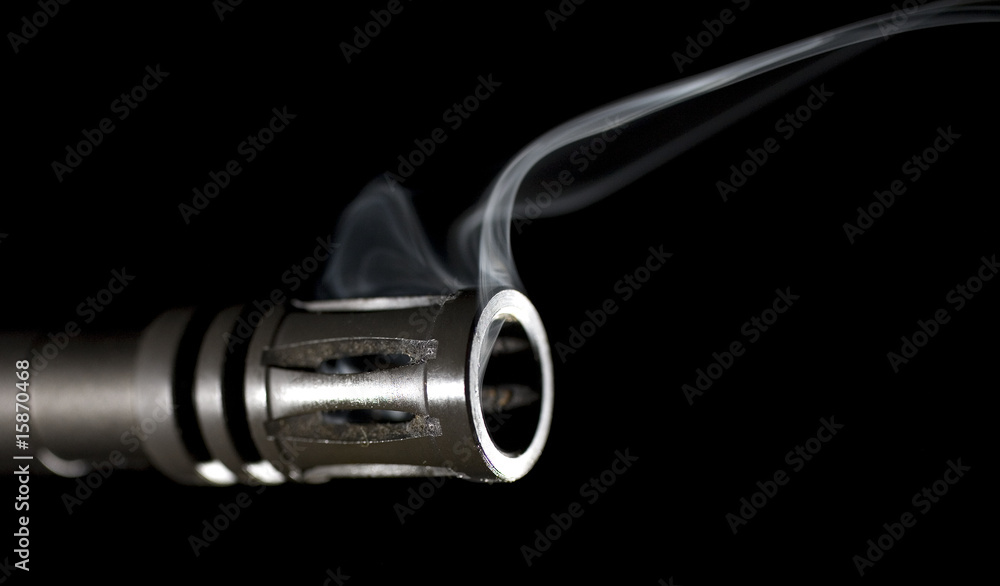 after the shot smoke continues to come from the flash hider on an ...