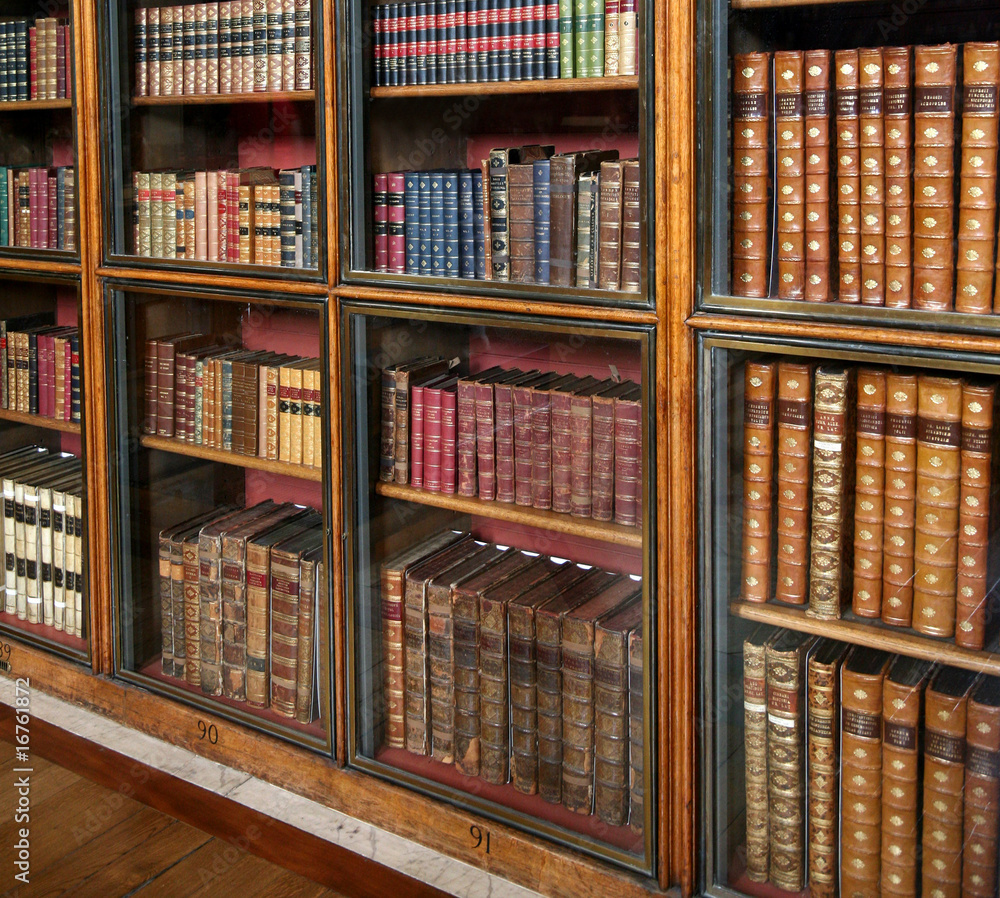 old books in glass fronted bookshelves, victorian library Stock Photo ...