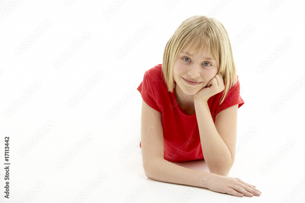Young Girl Lying On Stomach In Studio Stock Photo | Adobe Stock