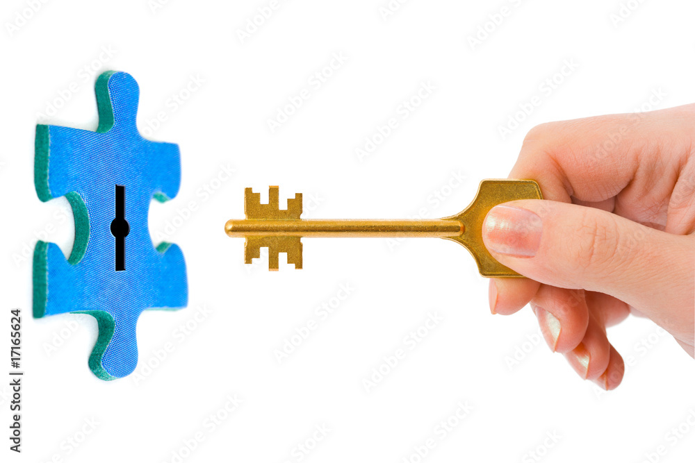 Hand with key and puzzle Stock Photo | Adobe Stock