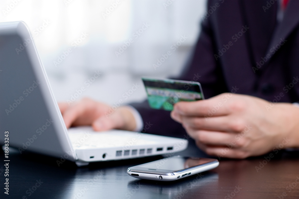 Businessman using his credit card for an online transaction Stock Photo ...