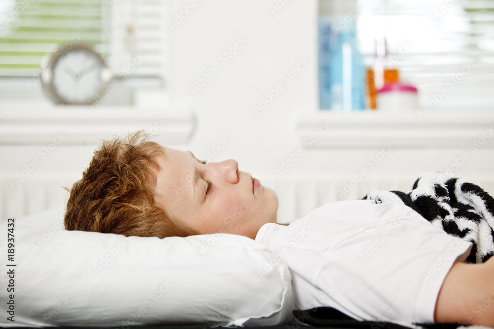 Boy sleeping on his back in bed Stock Photo | Adobe Stock
