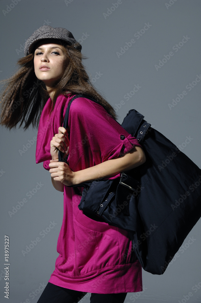 Fashion model with a big bag posing on white Stock Photo | Adobe Stock