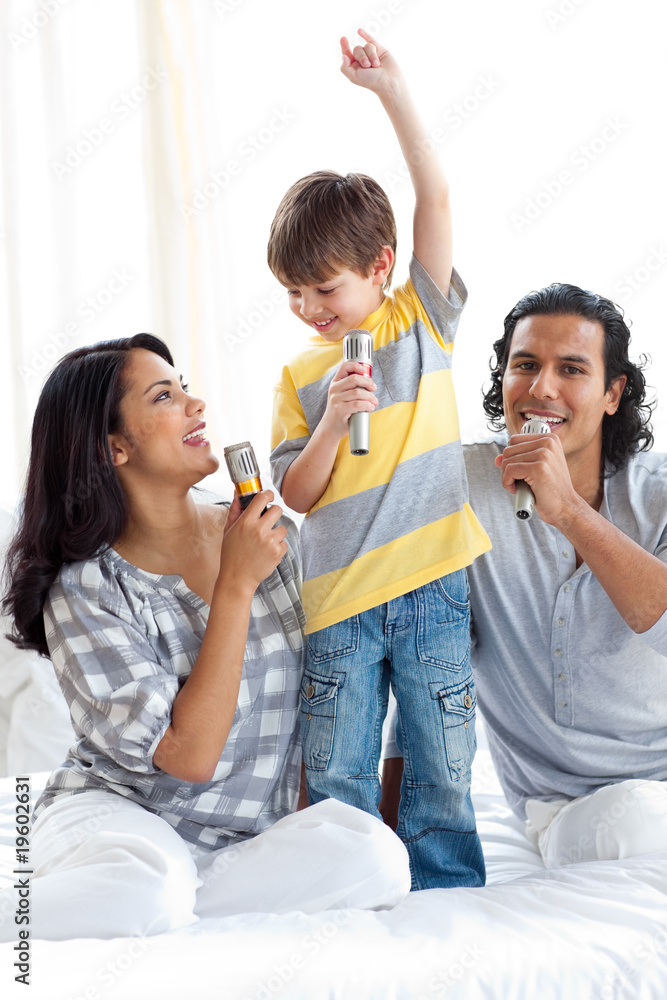 Adorable little boy singing with his parents Stock Photo | Adobe Stock