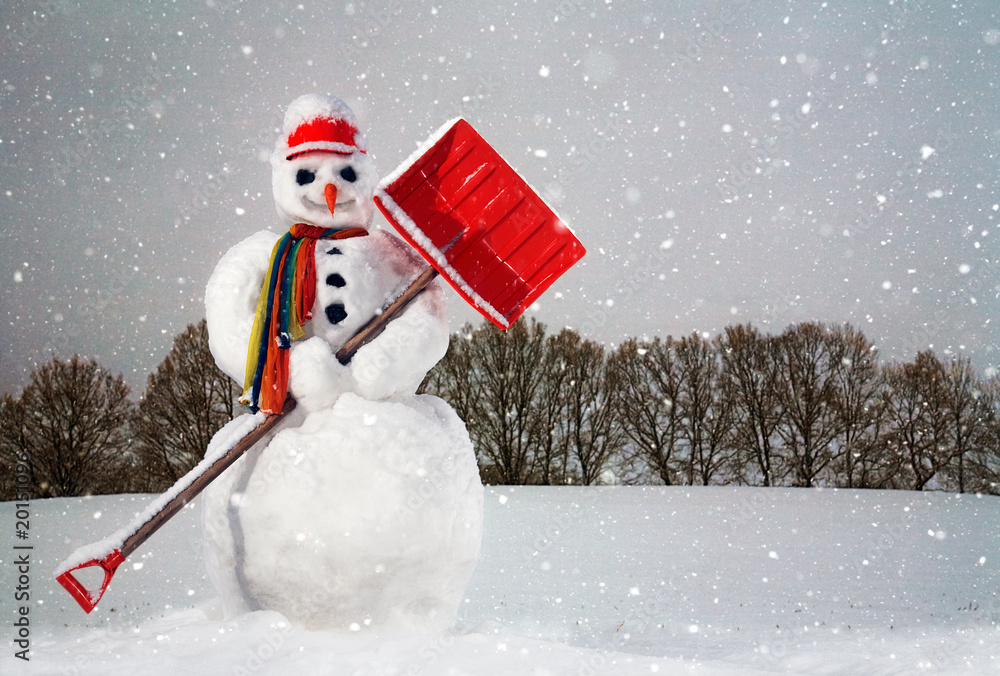 friendly snowman with a snow shovel during snowfall Stock Photo | Adobe ...