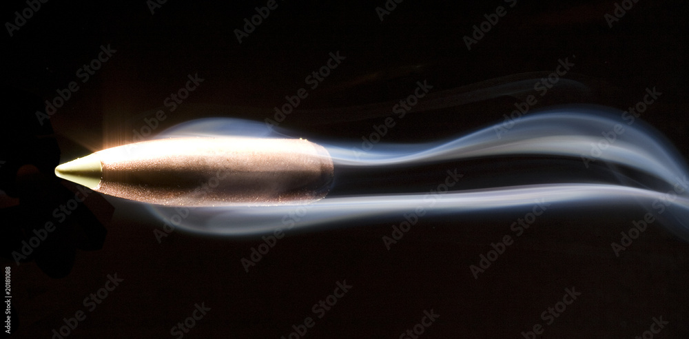 speeding bullet that has a copper jacket on a black background with ...