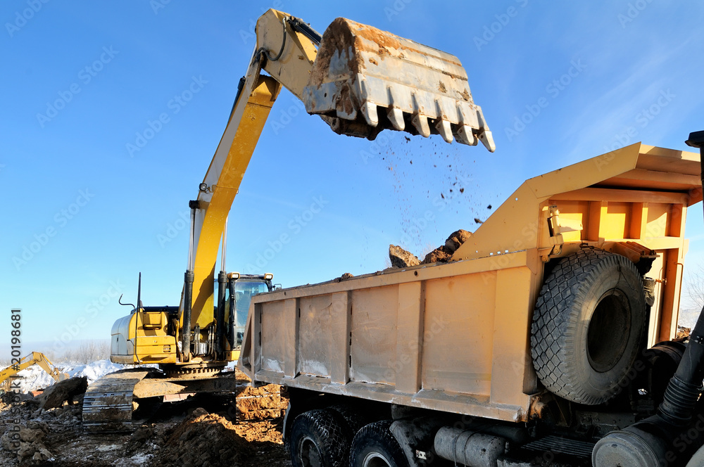 loader excavator loading earth to body of rear-end tipper Stock Photo ...