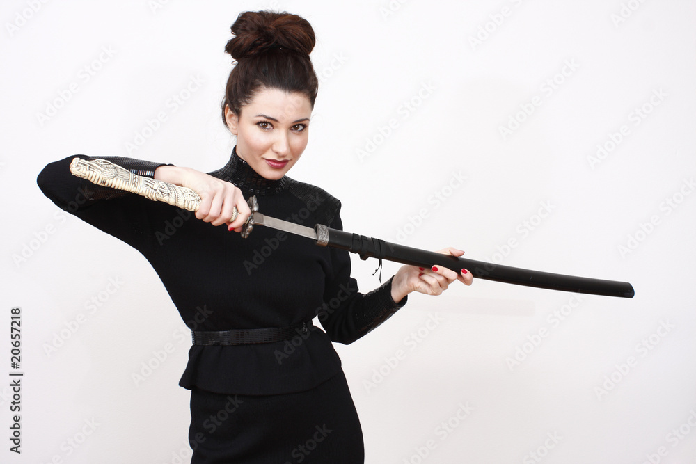 Beautiful woman wielding a samurai sword. Stock Photo | Adobe Stock