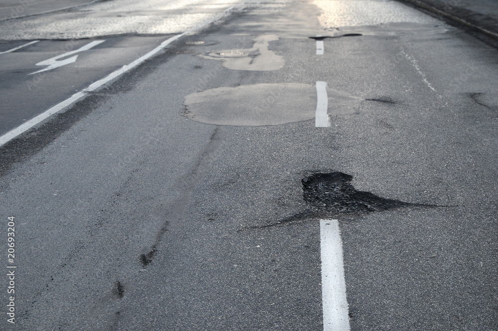 pothole in a road Stock Photo | Adobe Stock