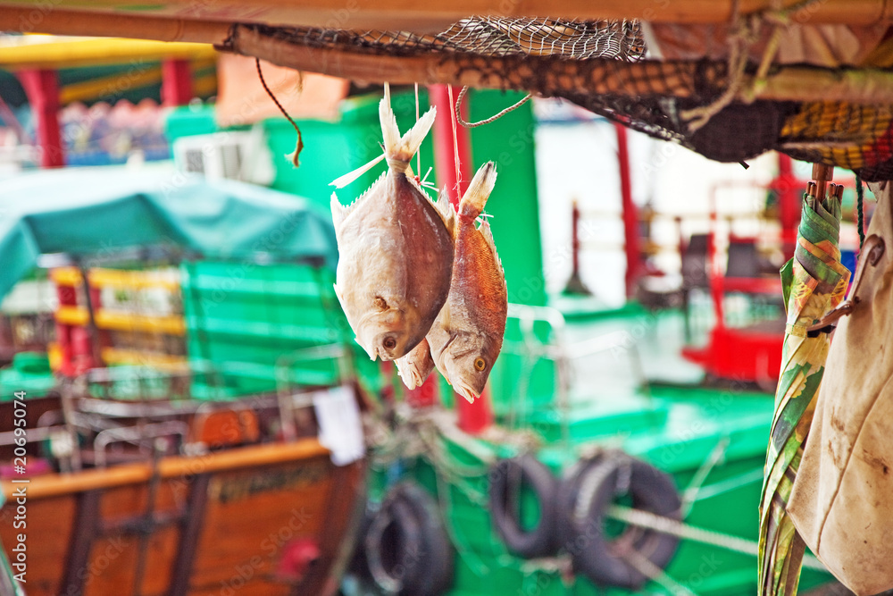 fish hanging on a boats roof to dry in the sun Stock Photo | Adobe Stock