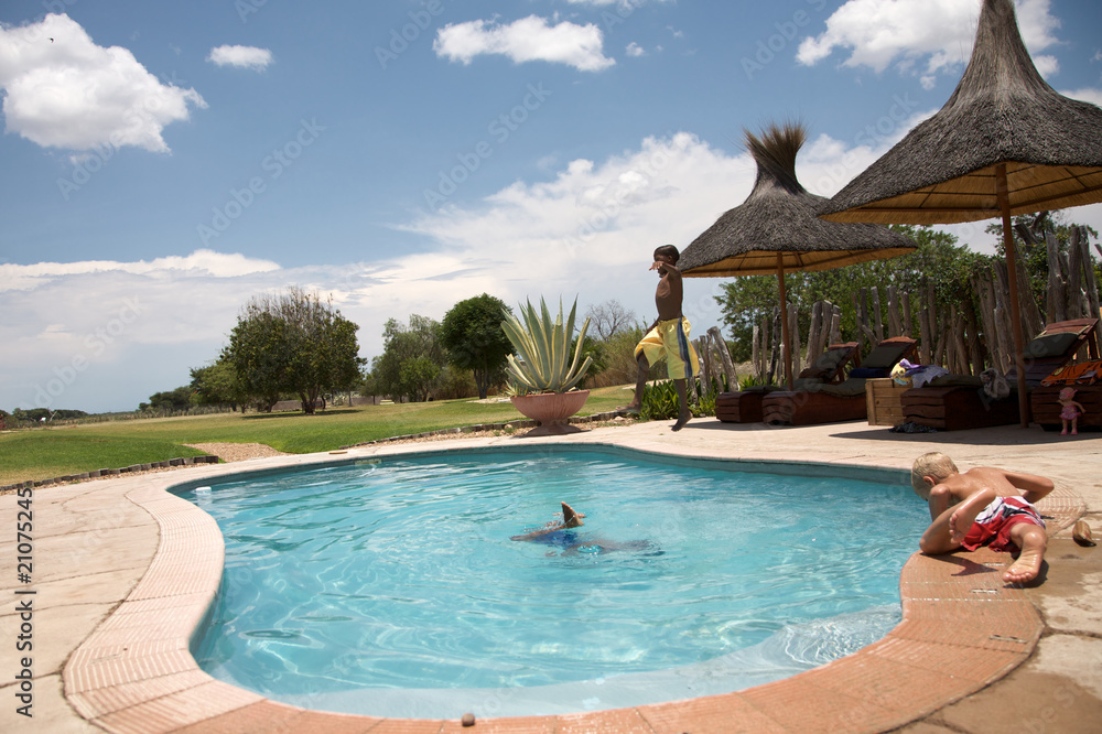 Kids playing around a swimming pool in Namibia Stock Photo | Adobe Stock