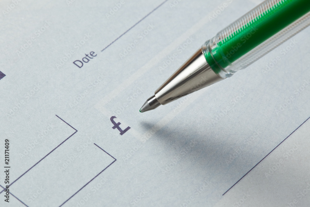 Writing a cheque with green ink Stock Photo | Adobe Stock