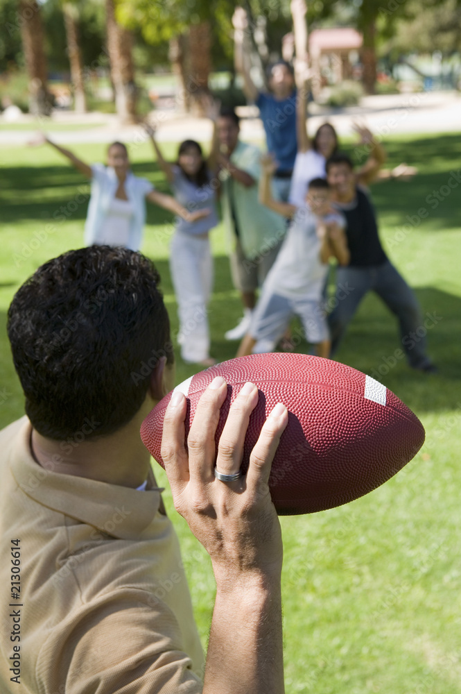 man throwing football to group of people back view. Stock Photo | Adobe ...