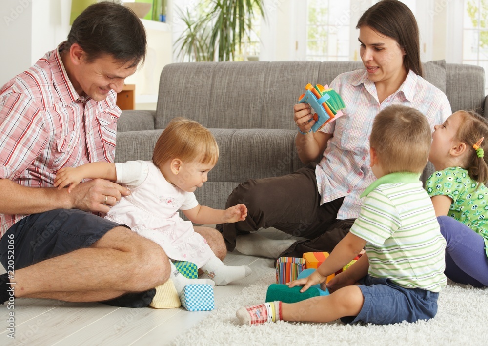 Happy nuclear family playing together at home Stock Photo | Adobe Stock