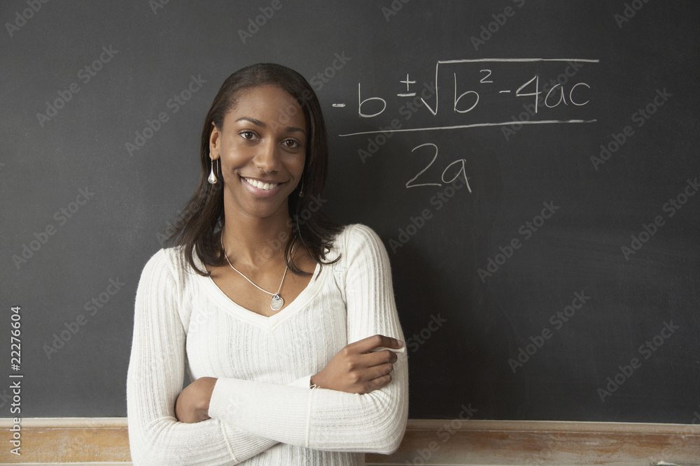 African female student next to math problem on blackboard Stock Photo ...