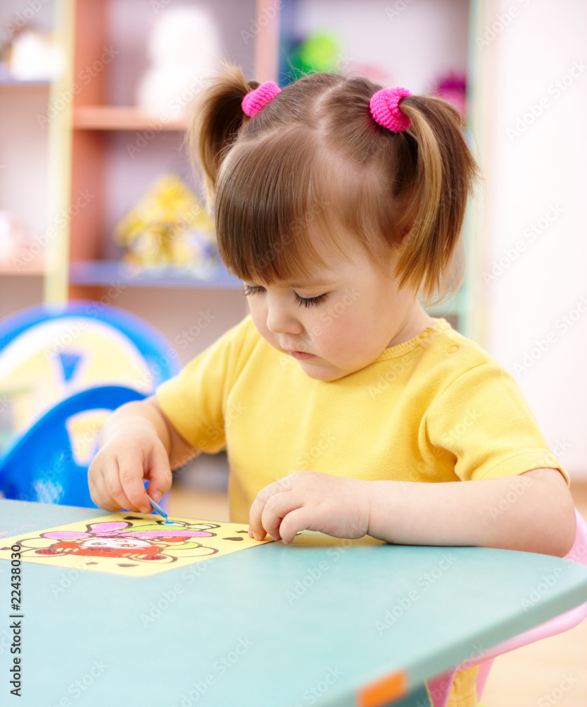 Little girl coloring a picture in preschool Stock Photo | Adobe Stock