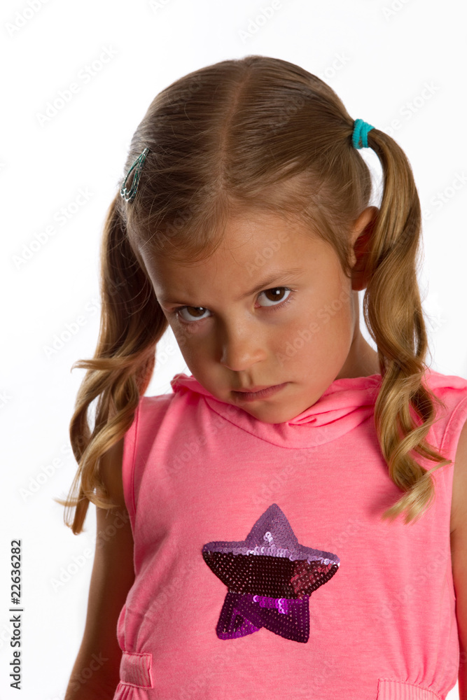 Pretty little girl with a grumpy expression on her face Photos | Adobe ...
