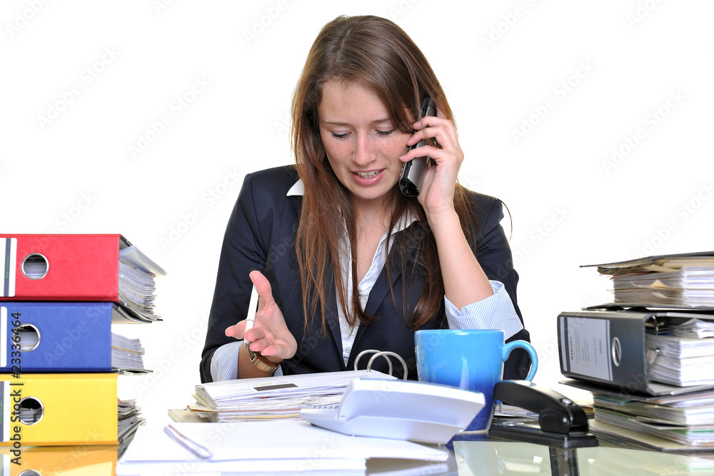 Junge Frau telefoniert im Büro zwischen Akten Stock-Foto | Adobe Stock