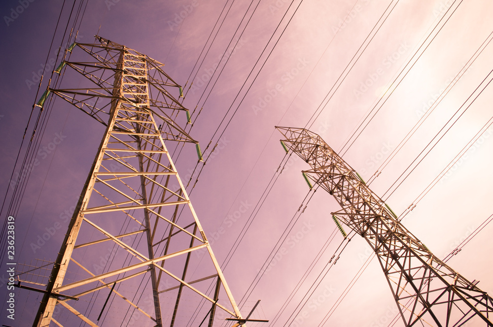 Overhead electricity power lines on transmission towers at sunset Stock ...
