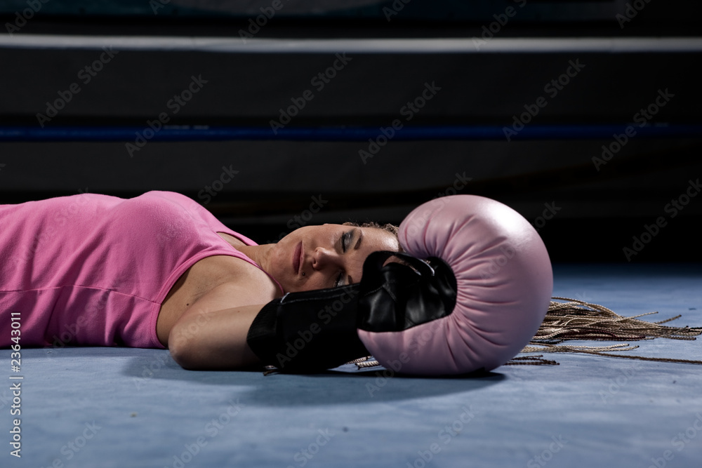 Blonde girl lying knocked out in a boxing ring Stock Photo | Adobe Stock