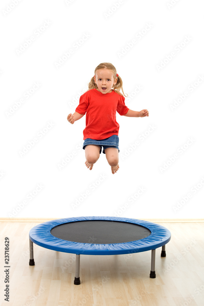 Little girl jumping on trampoline Stock Photo | Adobe Stock