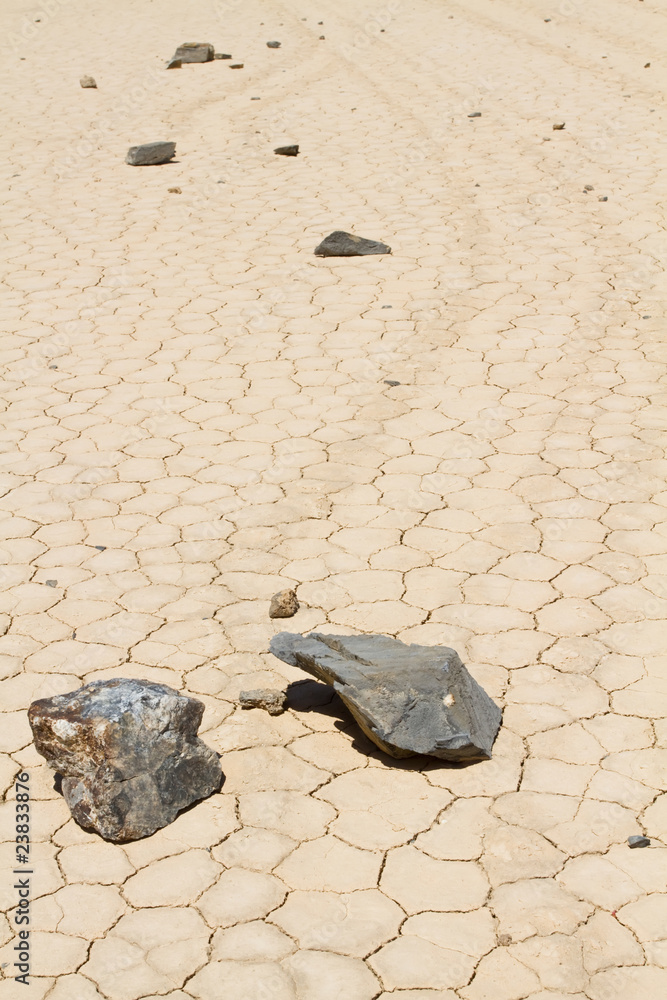 Moving rock on cracked desert ground Stock Photo | Adobe Stock