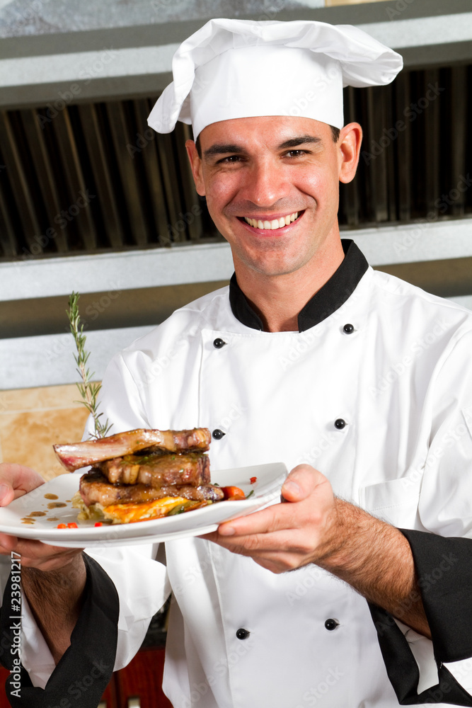 attractive male chef holding plate of food Stock Photo | Adobe Stock