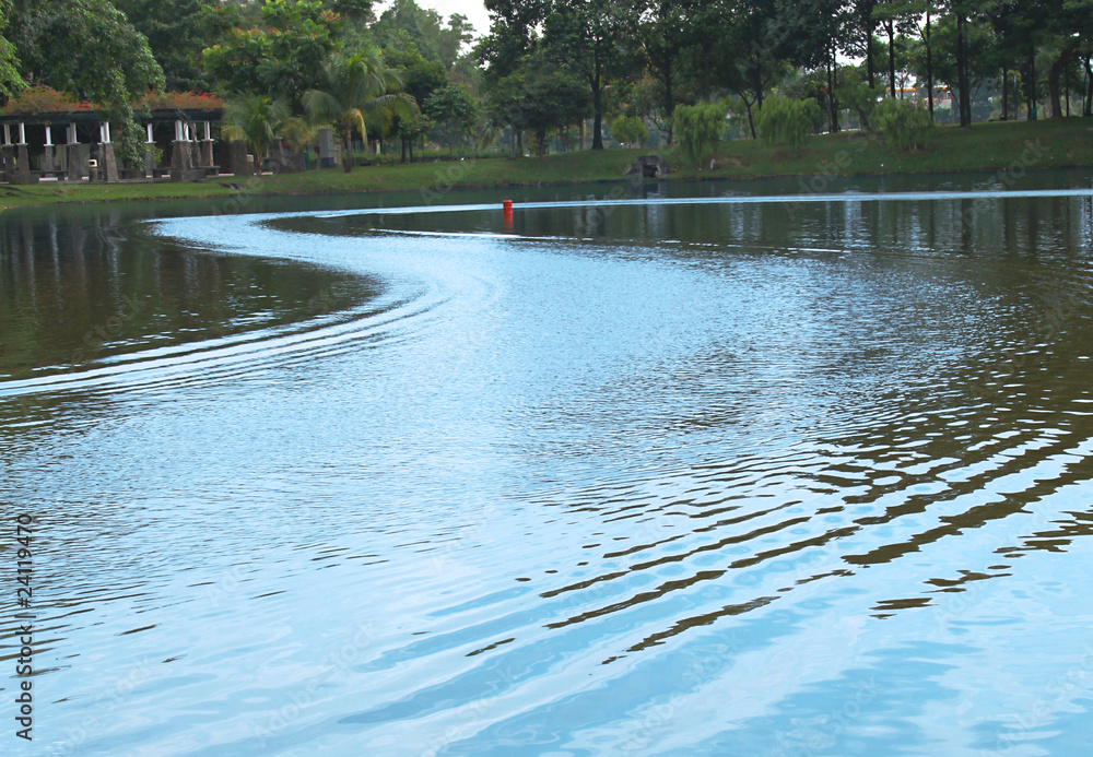 Water wake at calm lake Stock Photo | Adobe Stock