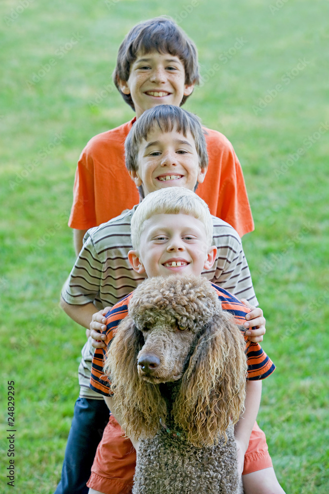 Three Boys Playing With Their Dog Stock-Foto | Adobe Stock